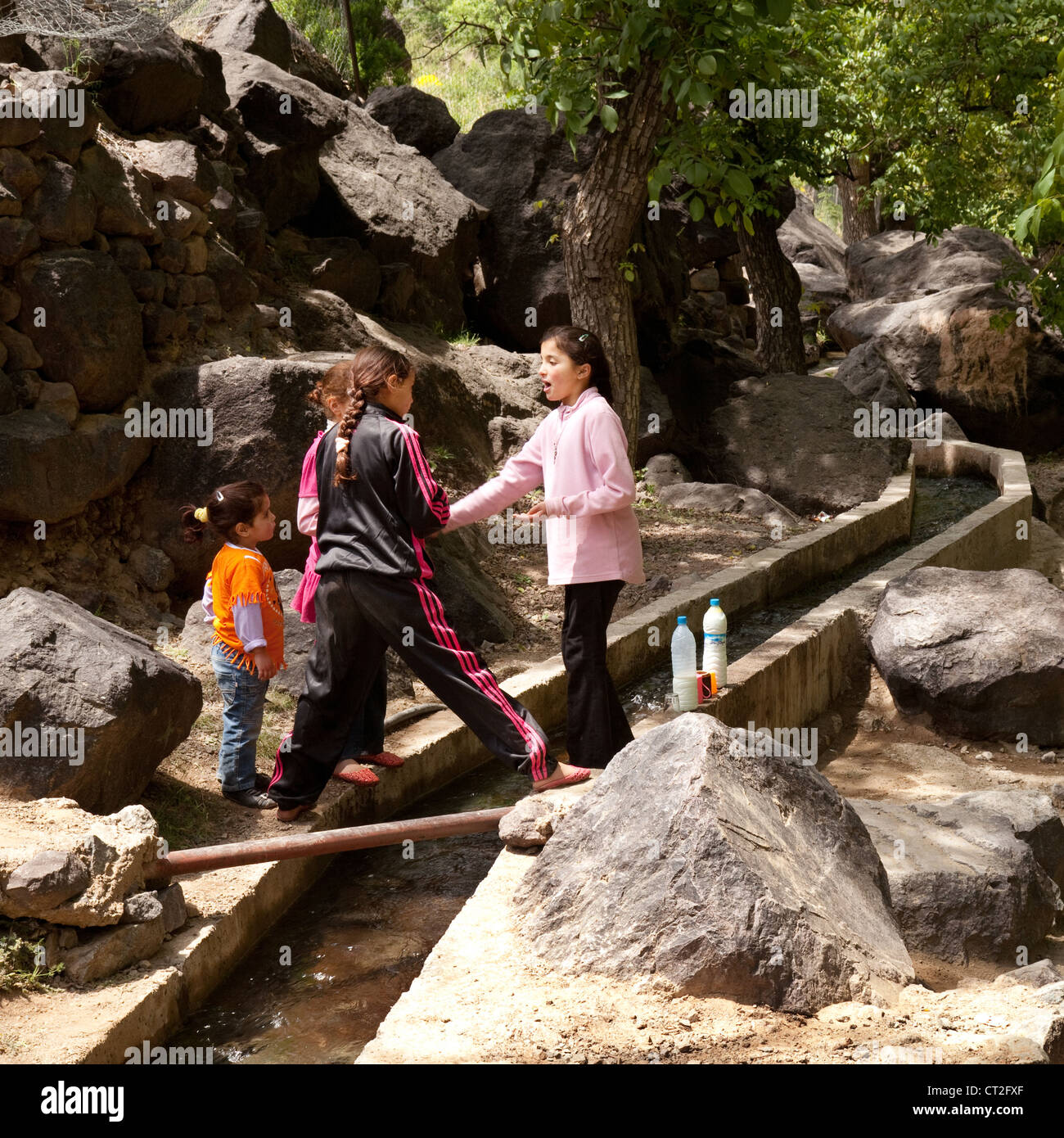 Moroccan children in the HIgh Atlas mountains playing by irrigation ...