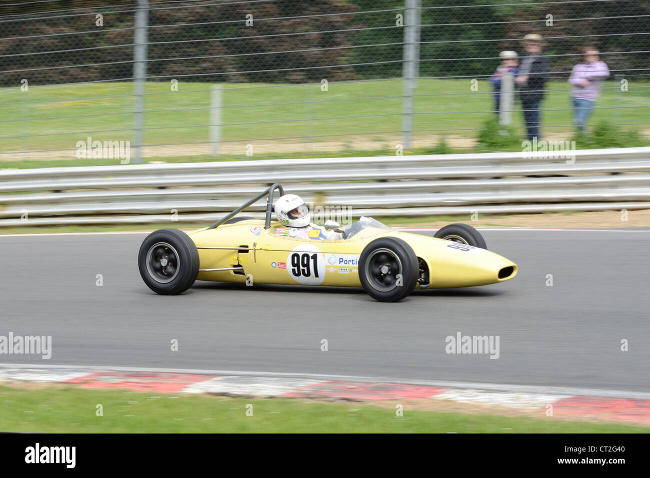 yellow race car on track Stock Photo - Alamy