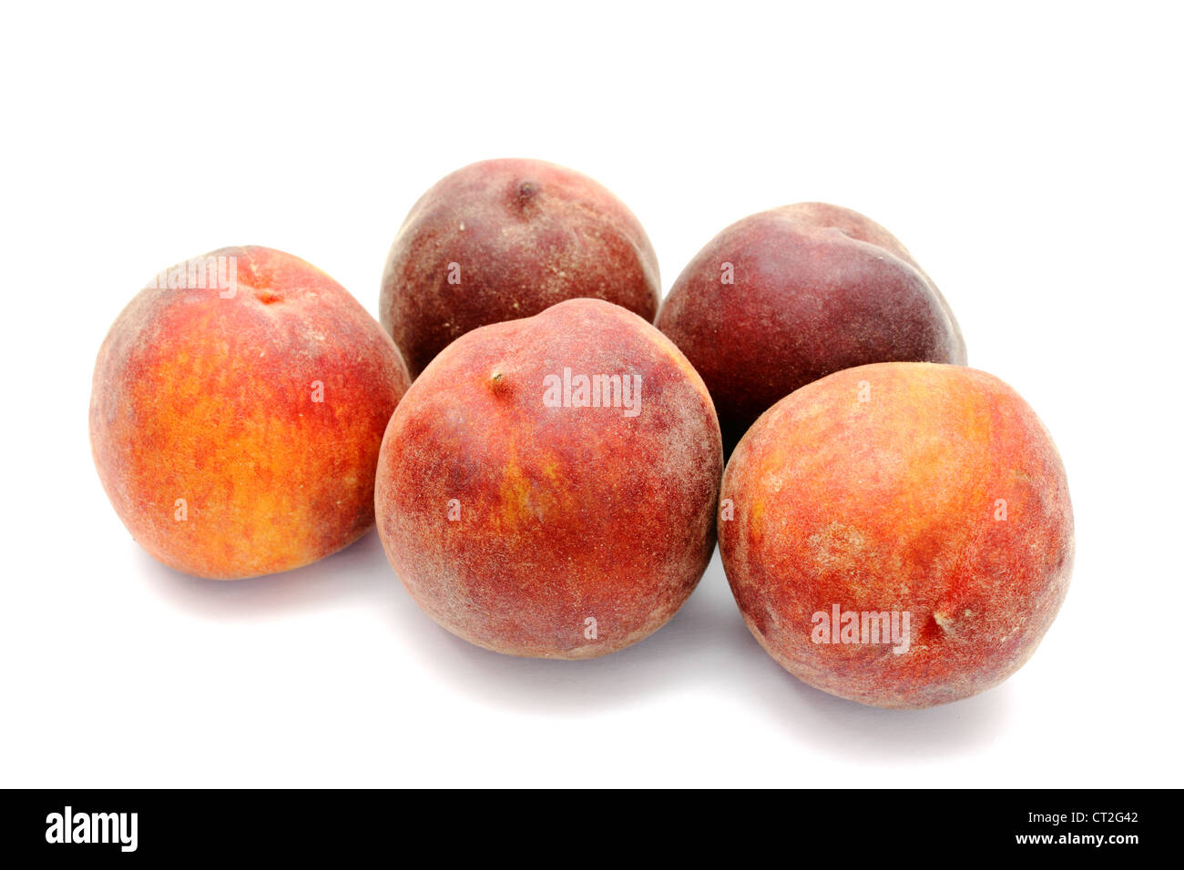 five colorful peaches over white background Stock Photo - Alamy
