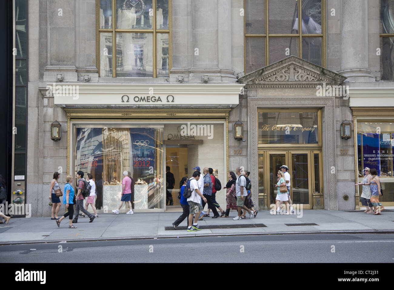 People pass by the Coca Cola Company on 5th Avenue in New York City ...