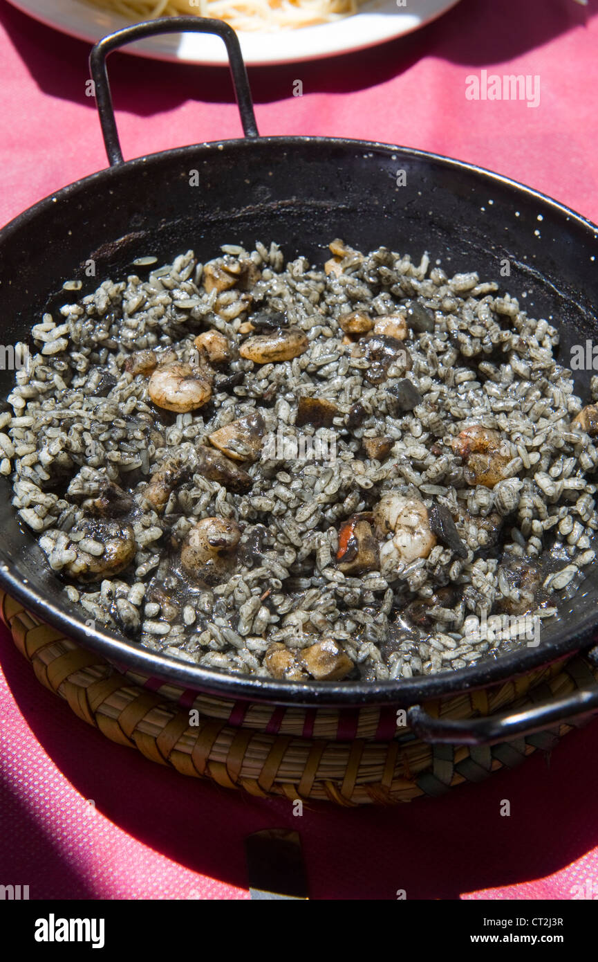 Arroz Negro or black rice dish served in spain made from squid ink ...