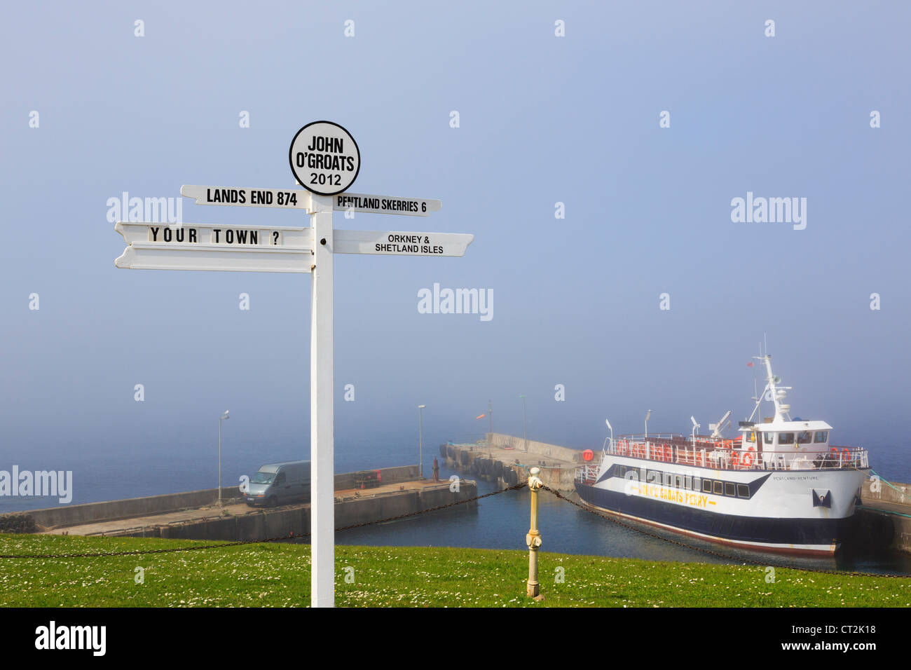Scene with signpost and ferry boat with sea mist on the north eastern ...
