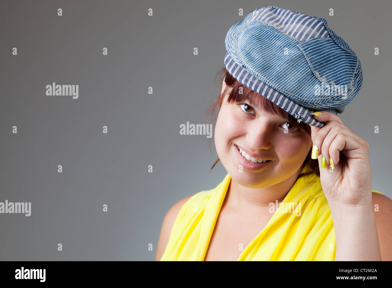Happy girl in a denim cap Stock Photo - Alamy