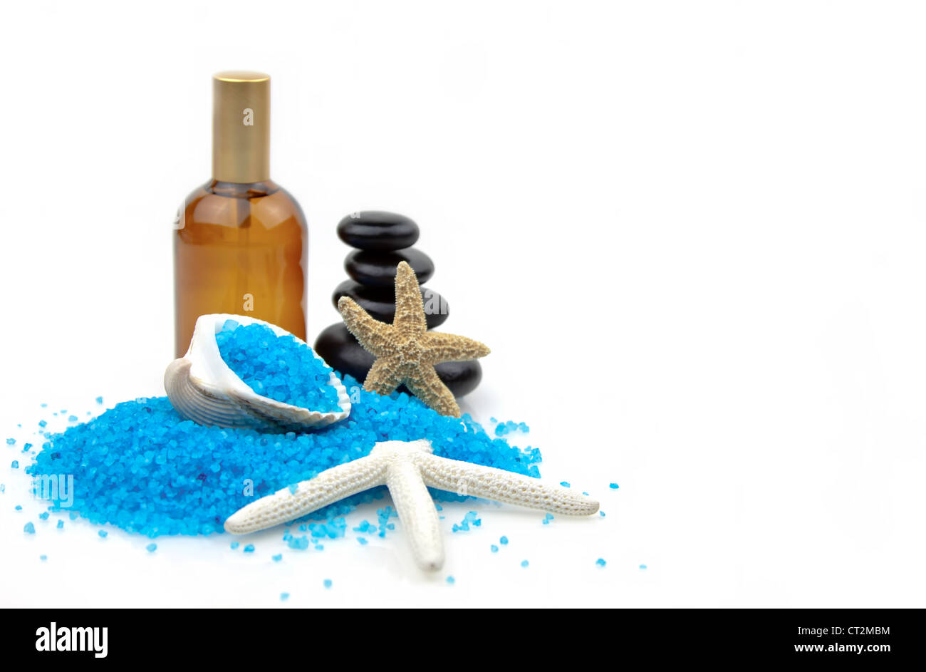 blue organic salt for spa with starfish,oil and stones on a white ...