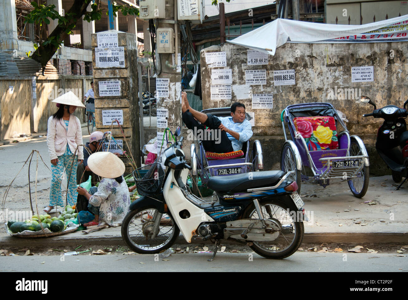 Rickshaw driver with his feet up, Street scene, Hue, Vietnam Stock ...