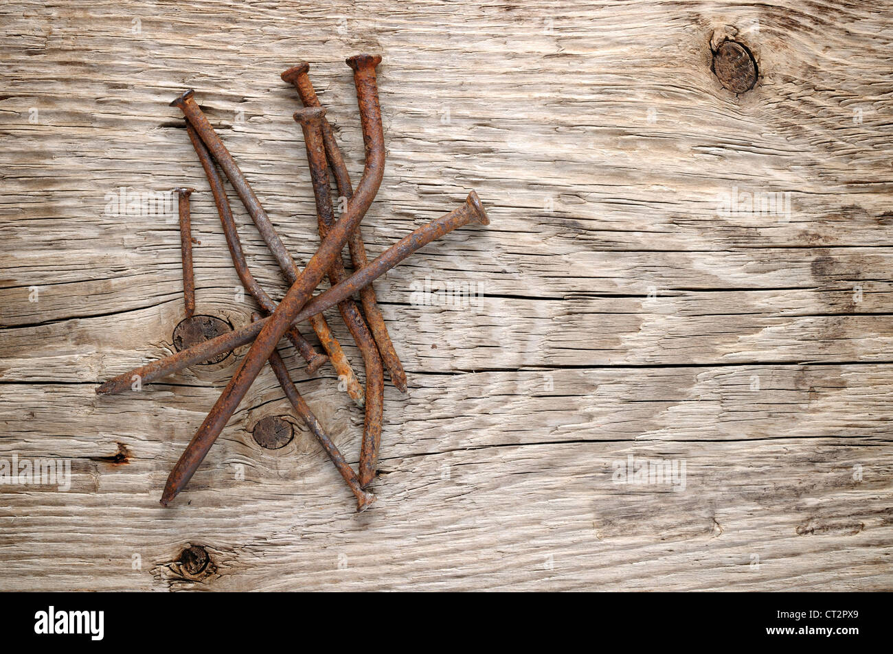 Old rusty nails on wood background Stock Photo - Alamy