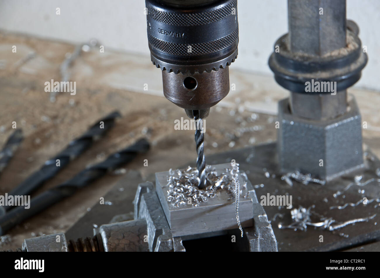 Drilling into a block of metal (macro view Stock Photo - Alamy