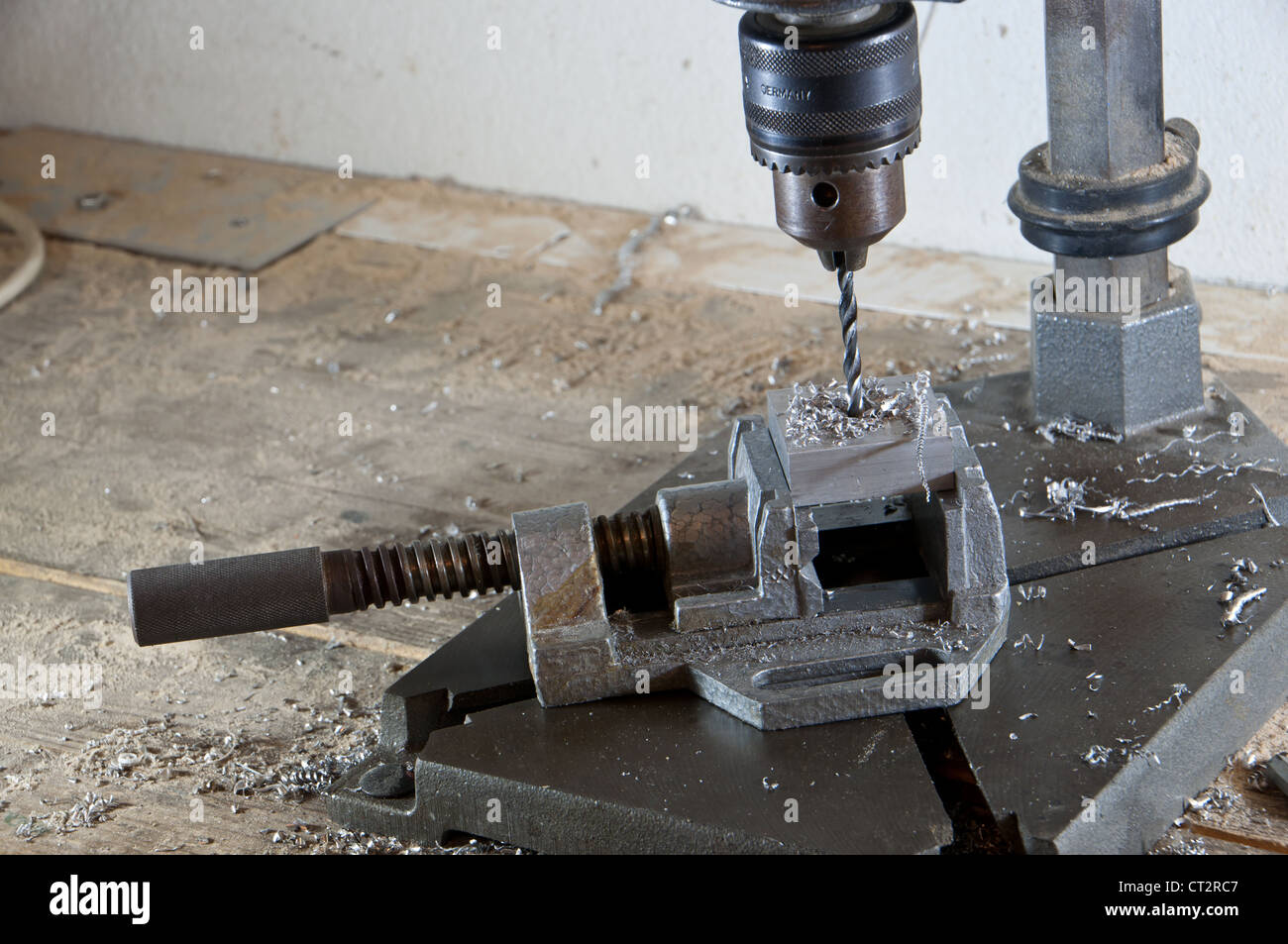 Drilling into a block of metal Stock Photo - Alamy