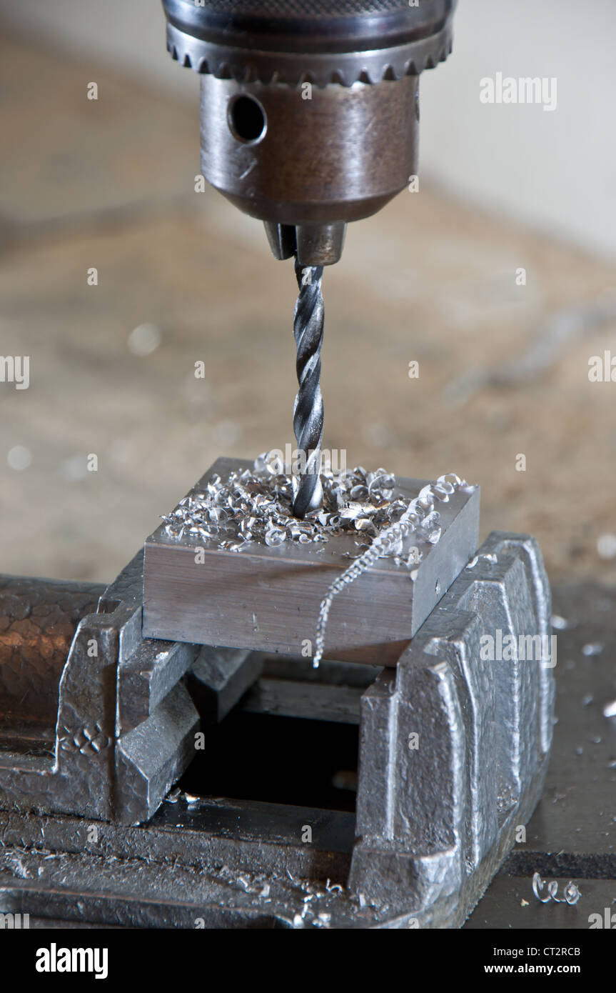 Drilling into a block of metal (macro view Stock Photo - Alamy