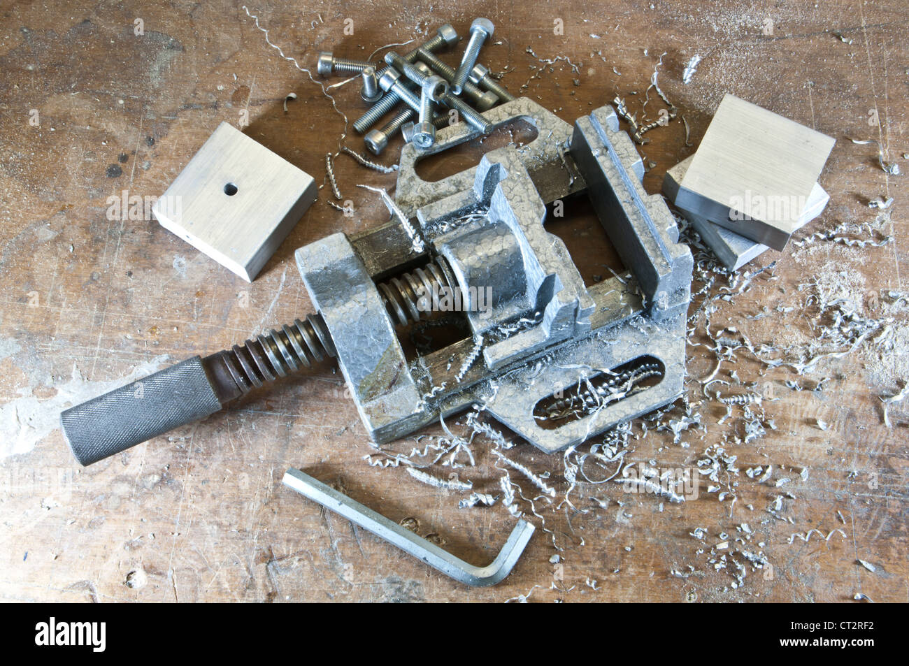 A metal vice on a wooden workbench Stock Photo - Alamy