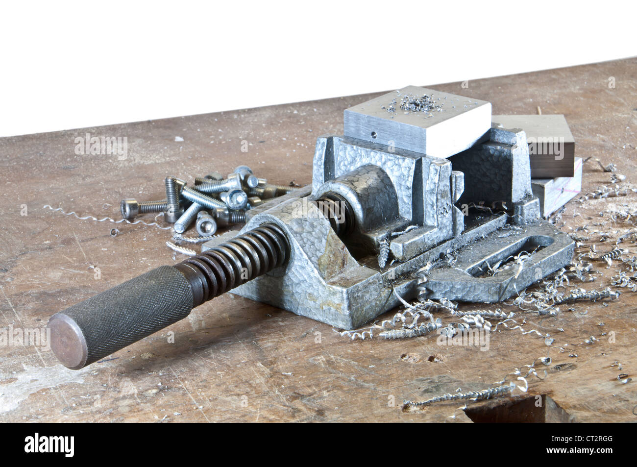 A metal vice on a wooden workbench isolated on white background Stock ...