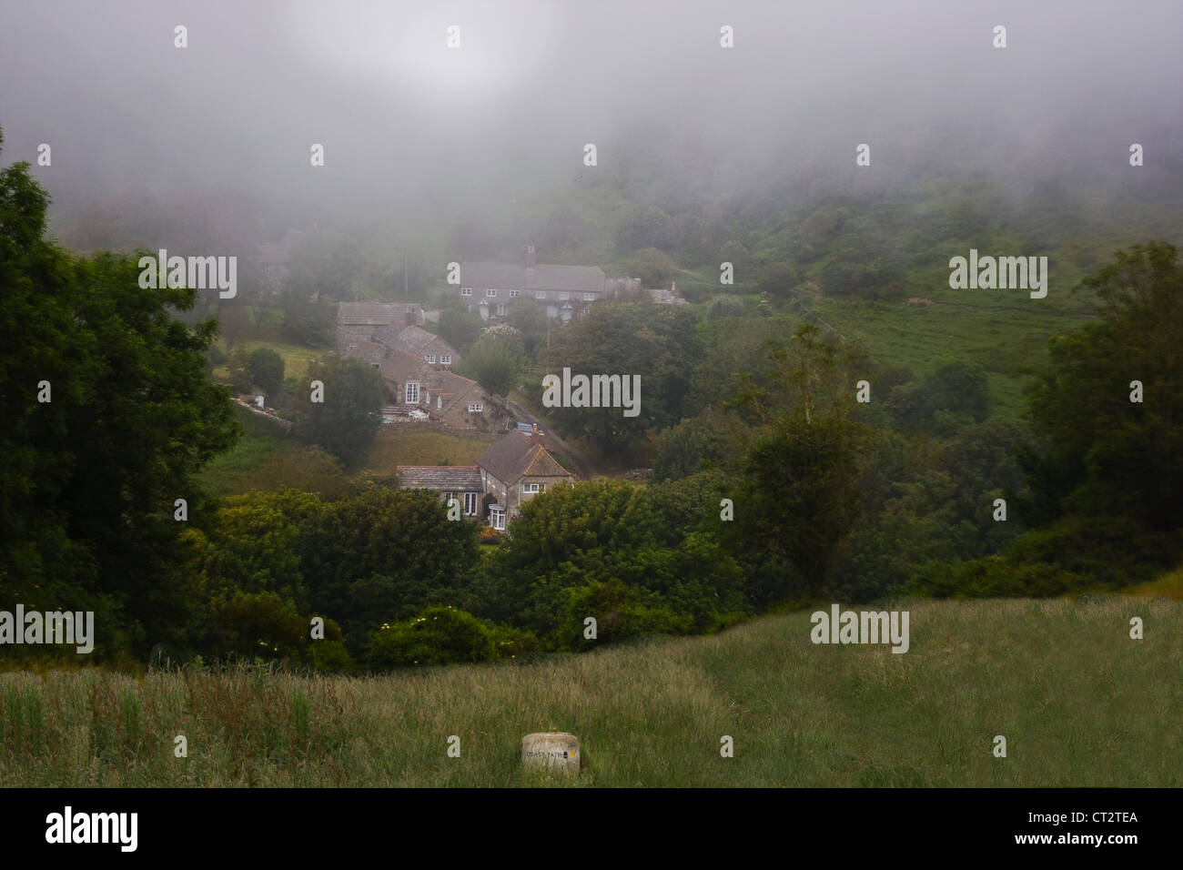 heavy mist or fog over a rural countryside village Stock Photo - Alamy