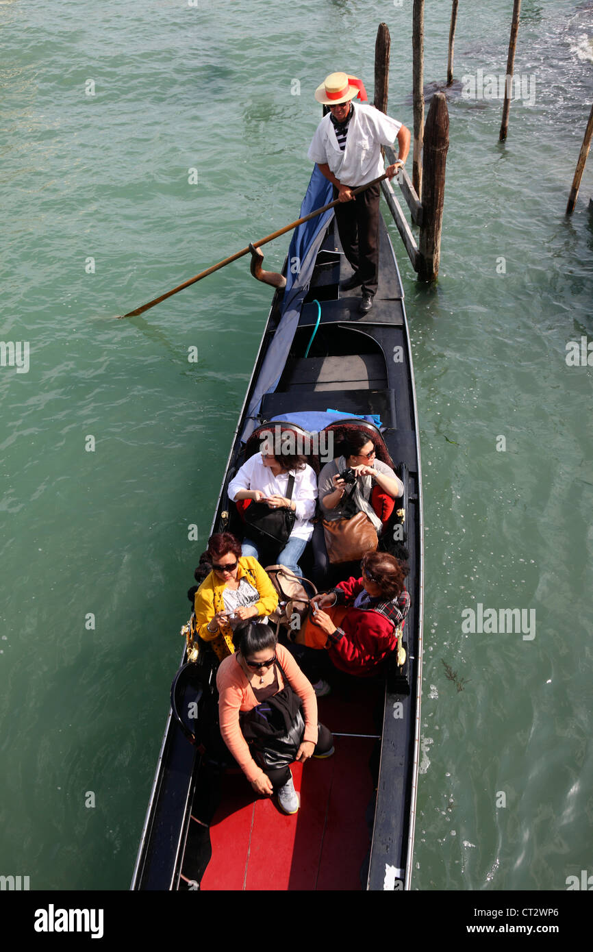 People riding in Gondola near San Marco on the Lagoon in Venice. Italy ...