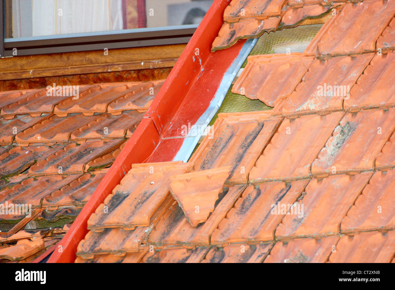damaged tiles on roof after a heavy summer storm Stock Photo - Alamy