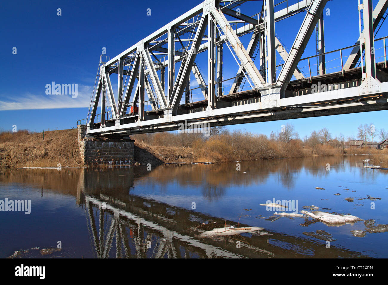 railway bridge through small river Stock Photo - Alamy