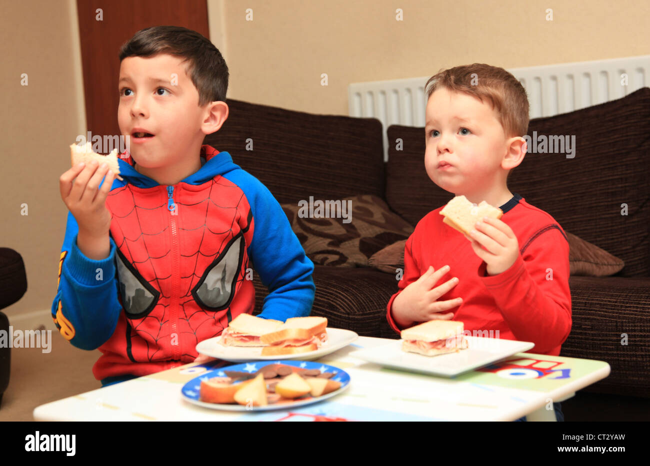 Boys eating sandwiches at home Stock Photo - Alamy