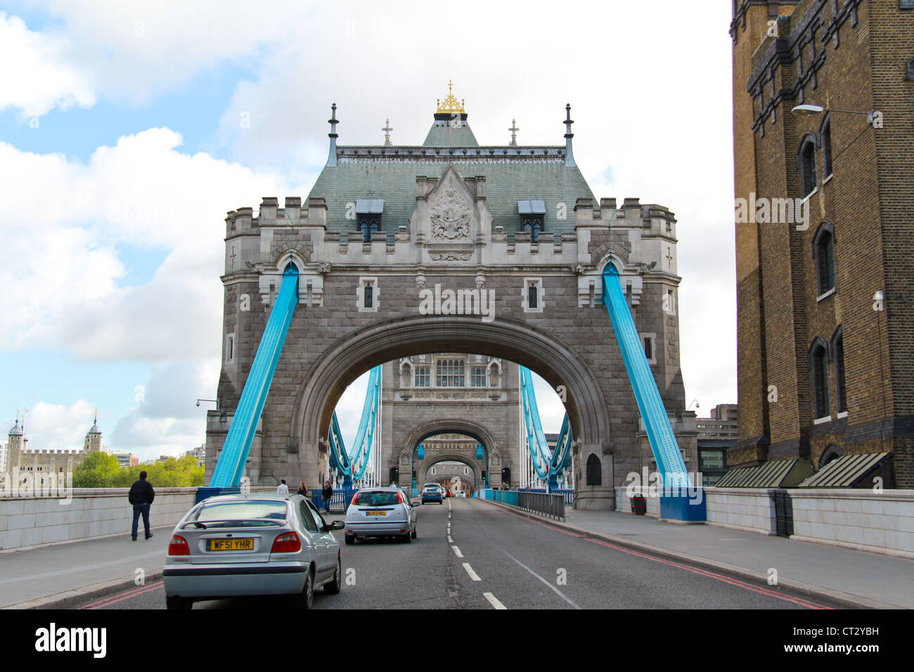 frontal view of Tower Bridge in London from road. Cloudy Stock Photo ...