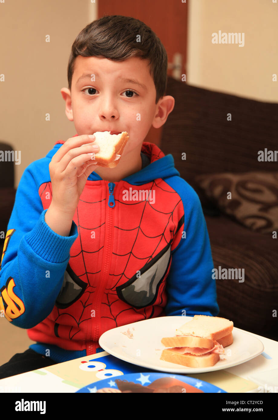 Boys eating sandwiches at home Stock Photo - Alamy