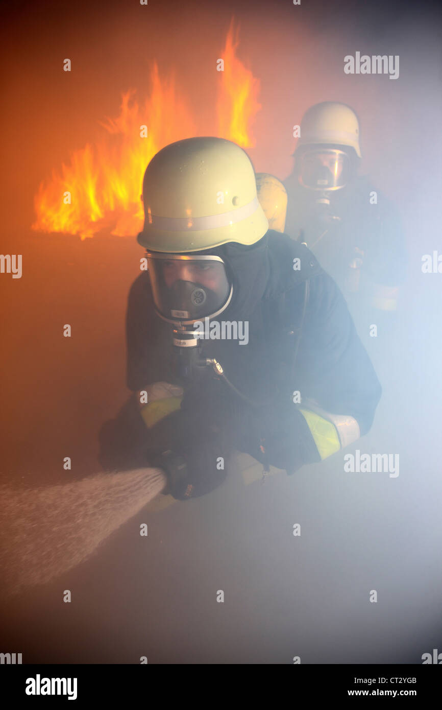 Fire service, fire men, fire fighting training at a fire training house ...