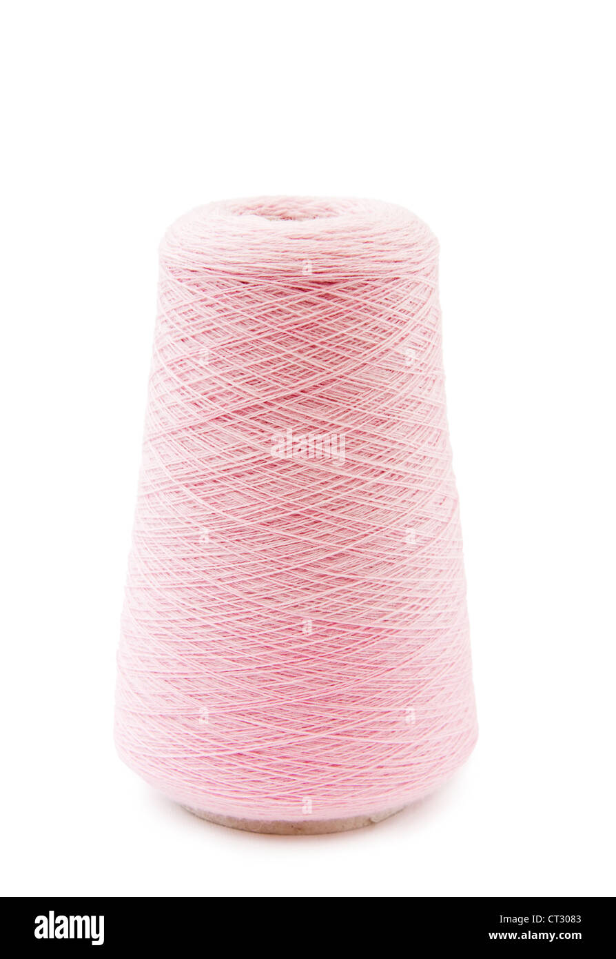 Crafts and tailors - big pink sewing thread. Isolated over white ...