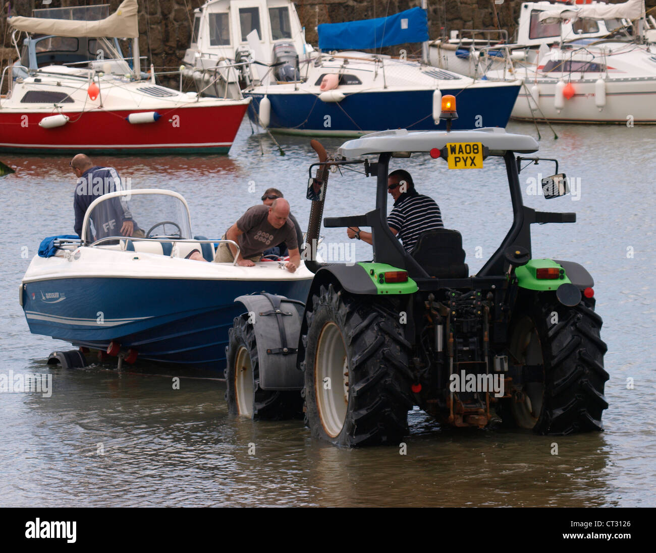 Launching boat from a trailer using a tractor, Lyme Regis, Dorset, UK ...