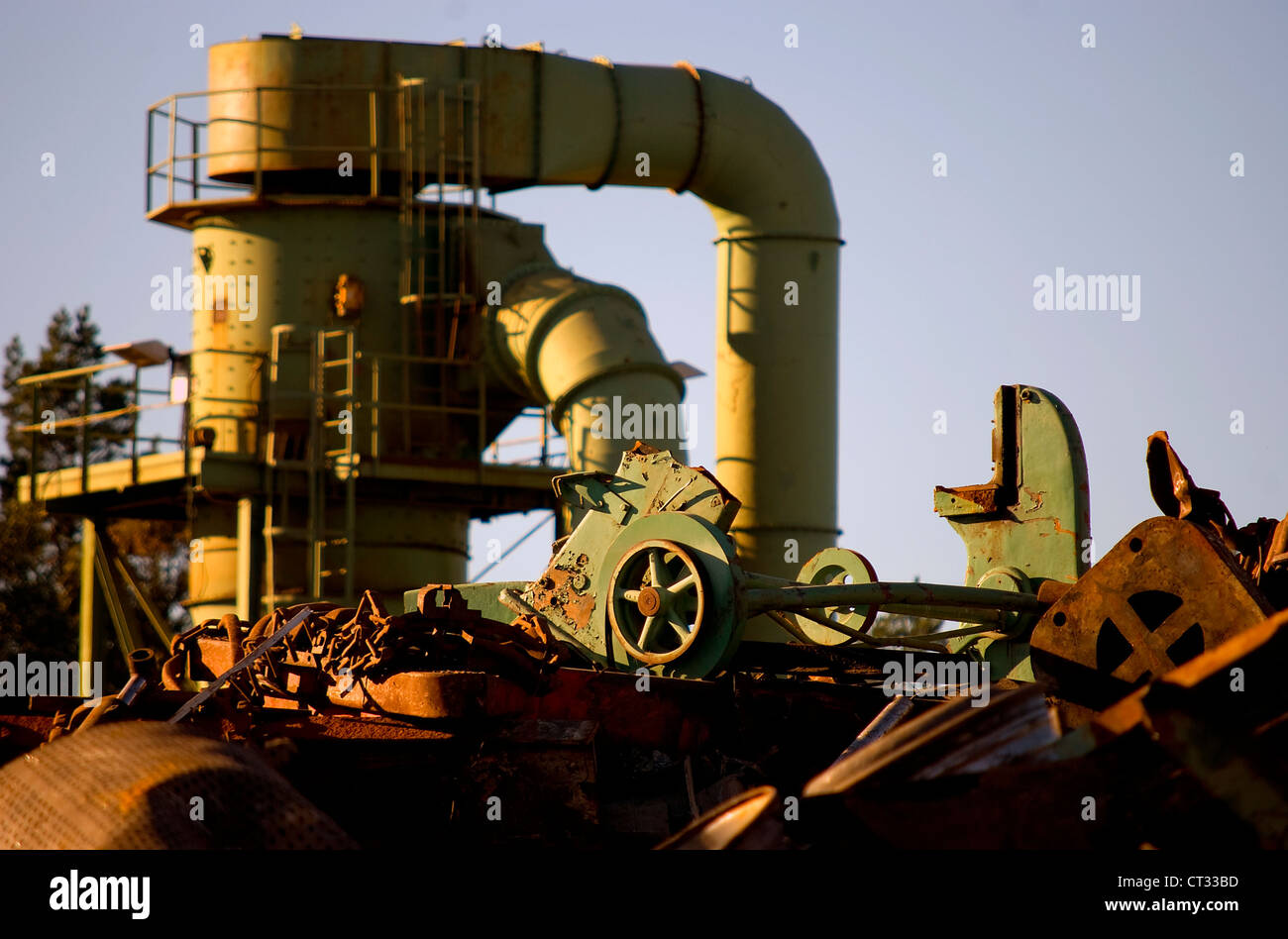 Machine behind the scrap heap works with fragmentation of the metal ...