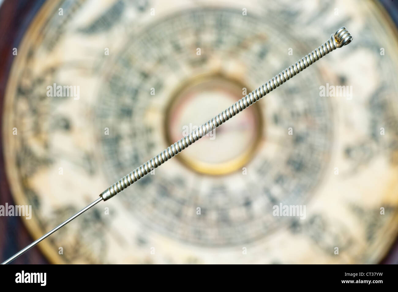 acupuncture needle over a Chinese compass for feng shui Stock Photo - Alamy