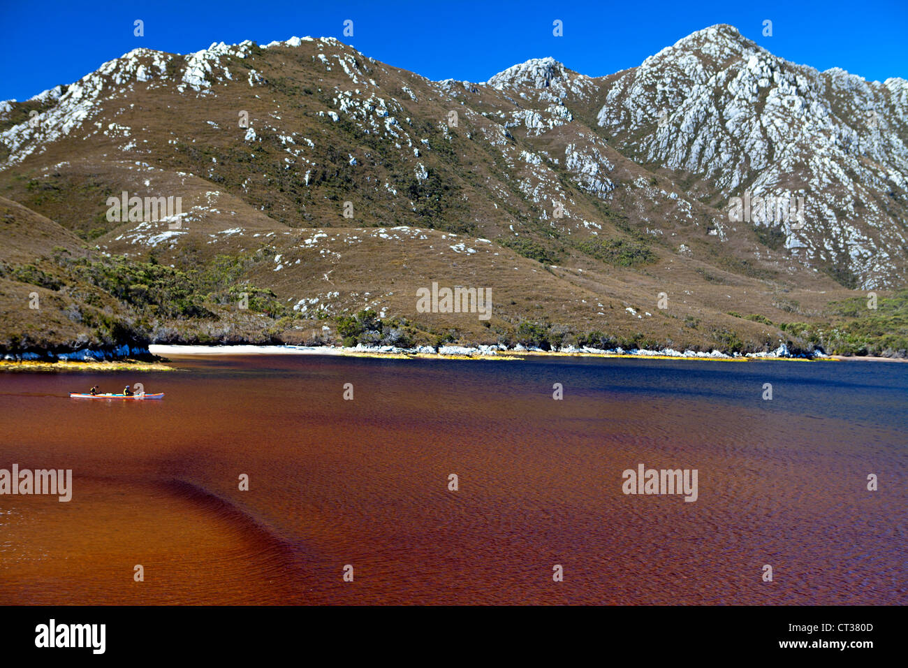 Kayak in Bramble Cove below Mt Stokes in Tasmania's Southwest National ...