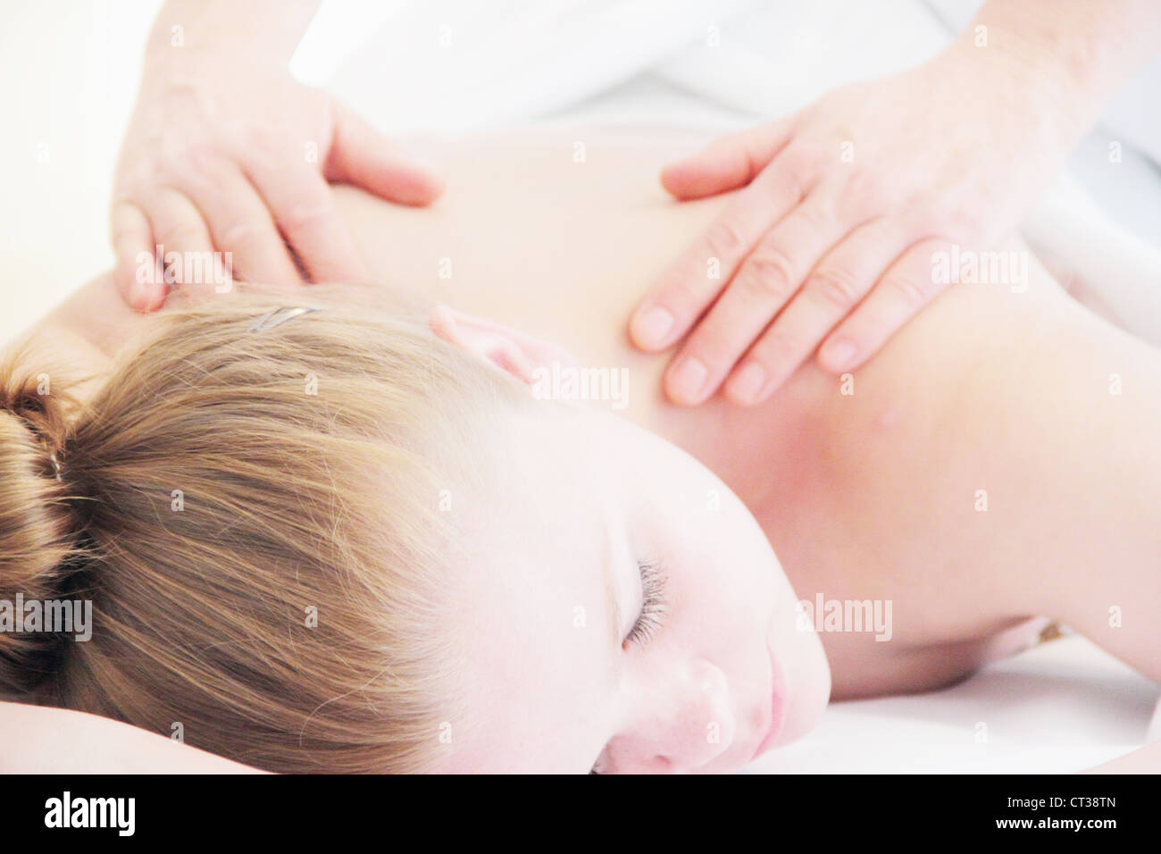 Woman laying on massage table in spa hi-res stock photography and ...