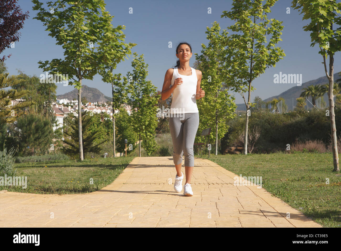Woman running in park Stock Photo - Alamy