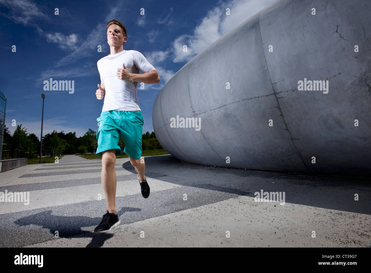 Man running in industrial area Stock Photo - Alamy
