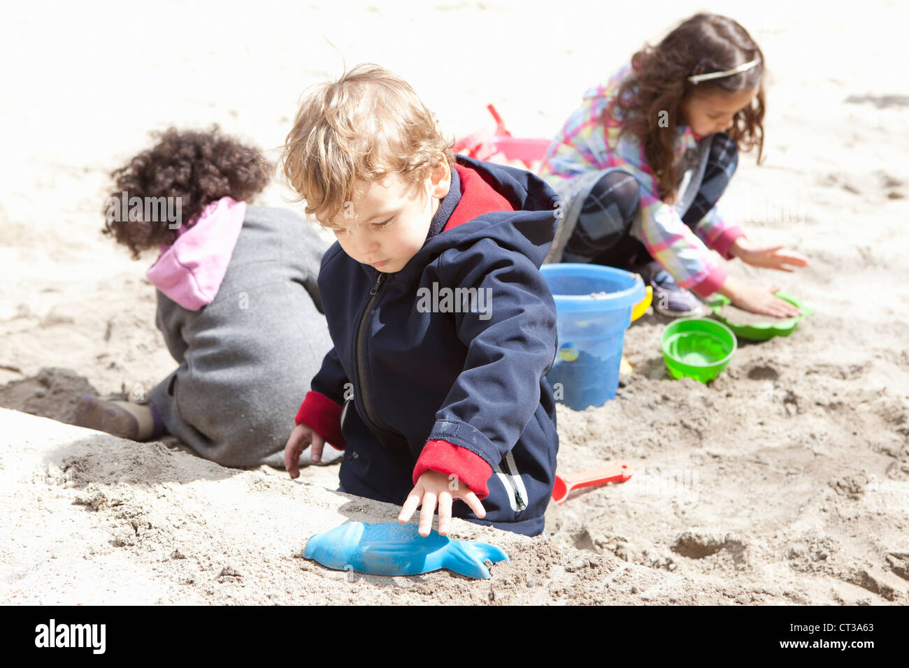 Children playing with sand in playground Stock Photo - Alamy