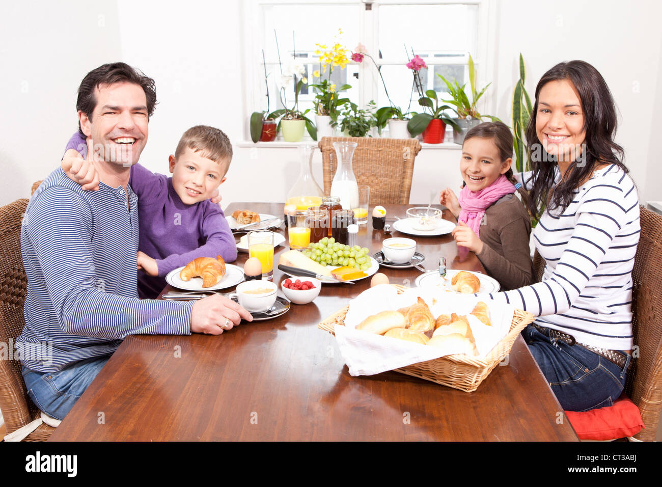 Family eating breakfast at table Stock Photo - Alamy