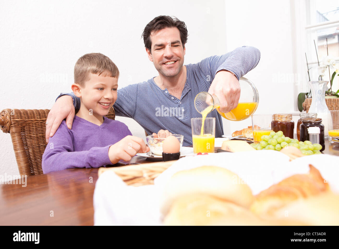 Father and son eating breakfast Stock Photo - Alamy