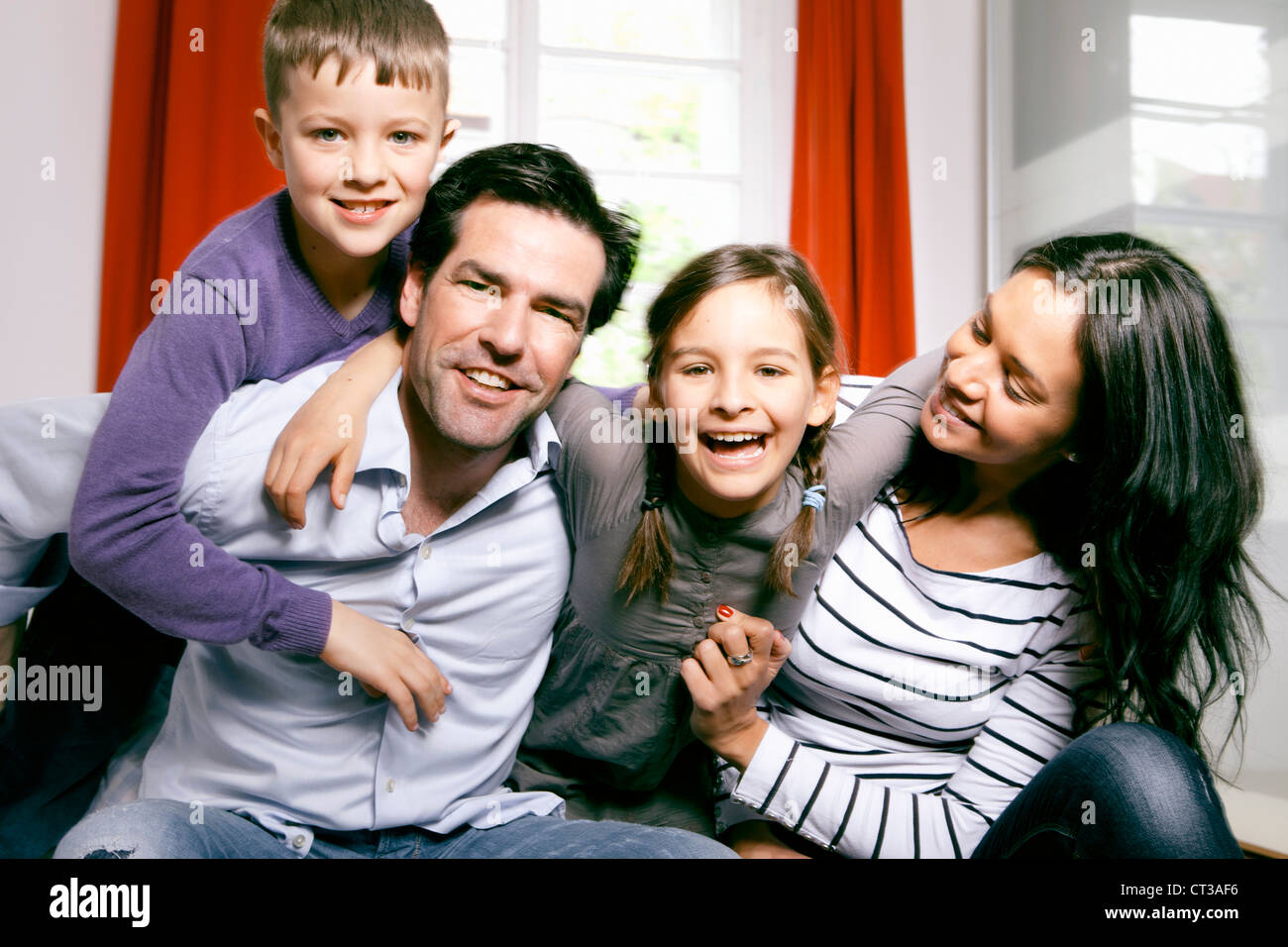 Family smiling together on bed Stock Photo - Alamy