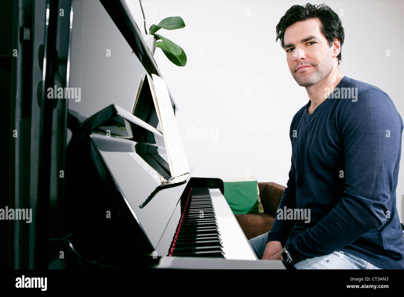 Man sitting at piano Stock Photo - Alamy