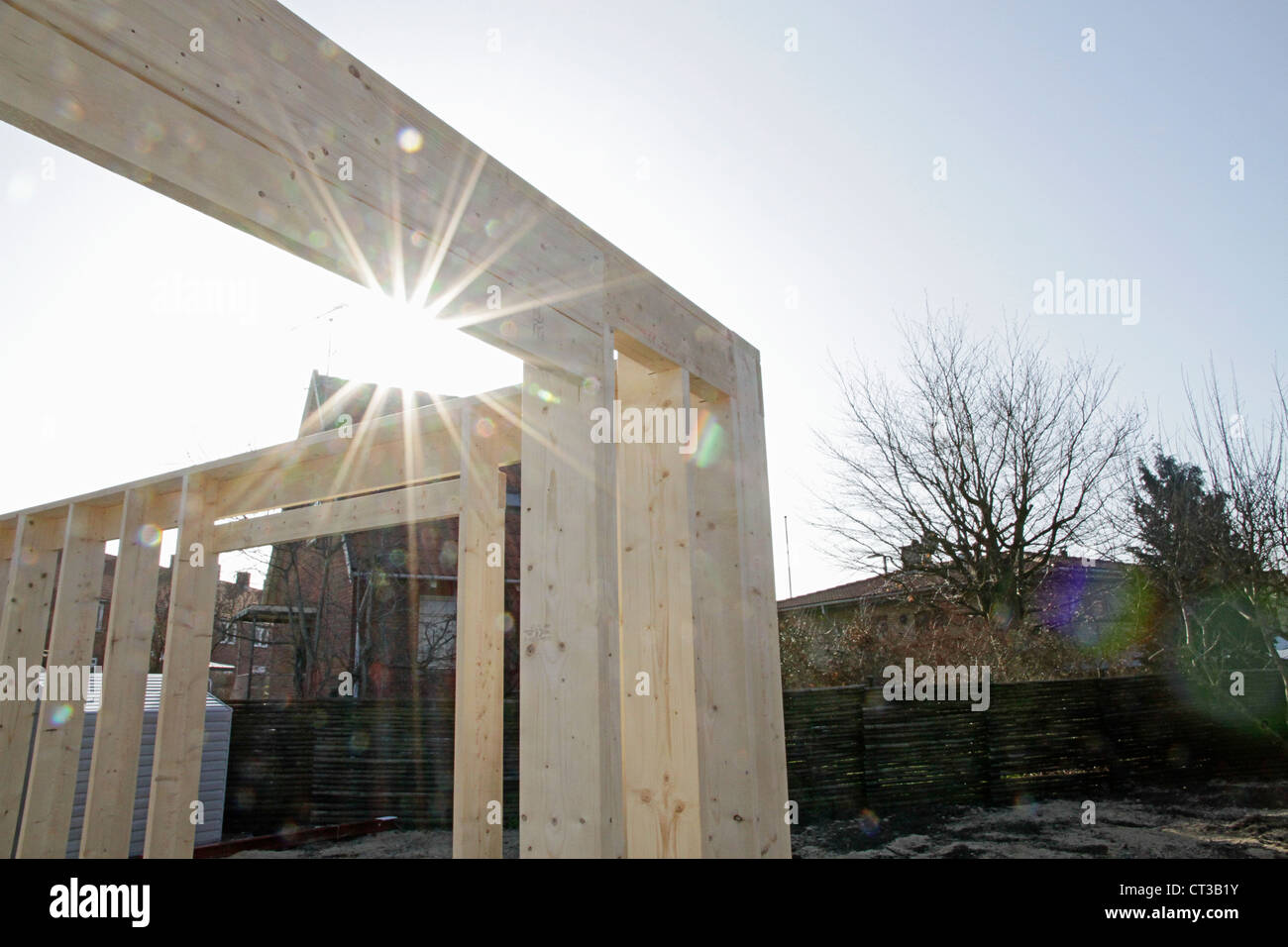 Sun shining on new building on site Stock Photo - Alamy