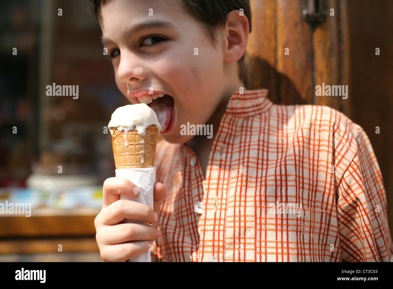 CHILD EATING SWEETS Stock Photo - Alamy