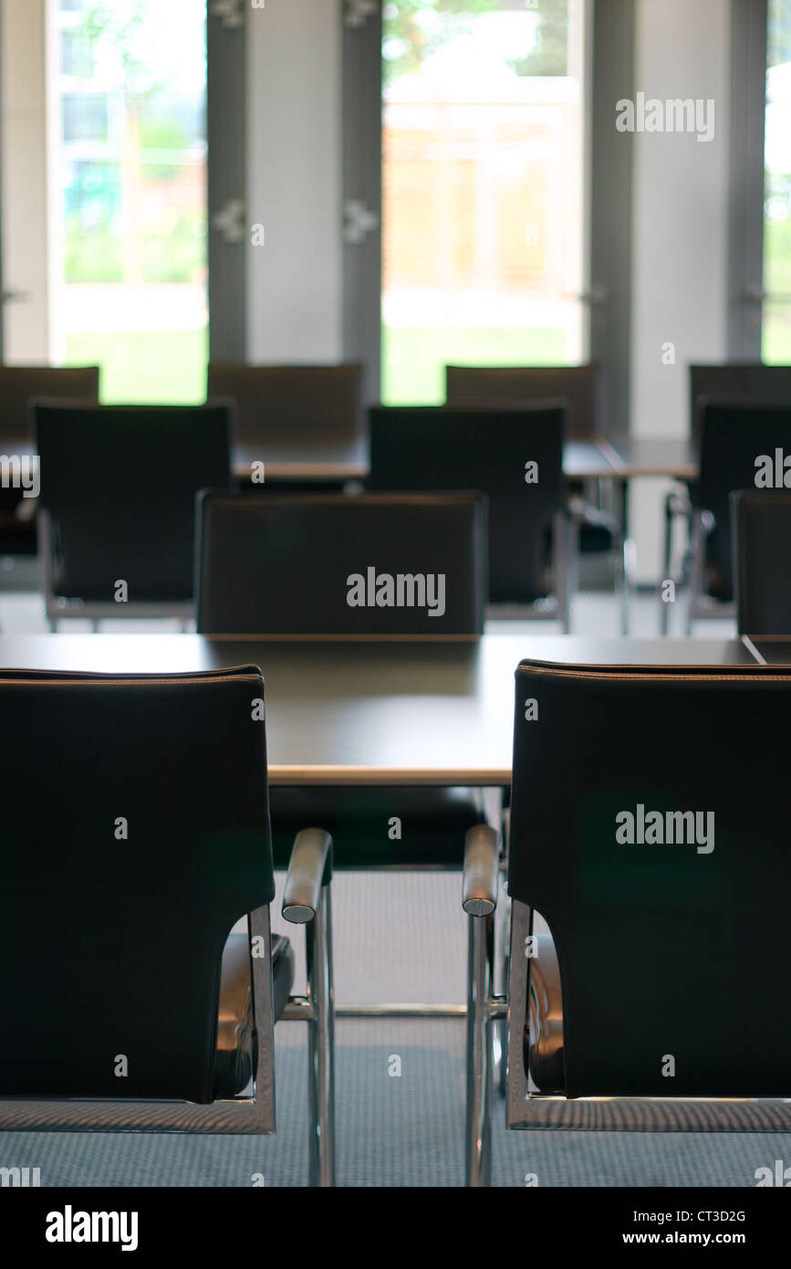 Conference room with black chairs and tables Stock Photo - Alamy