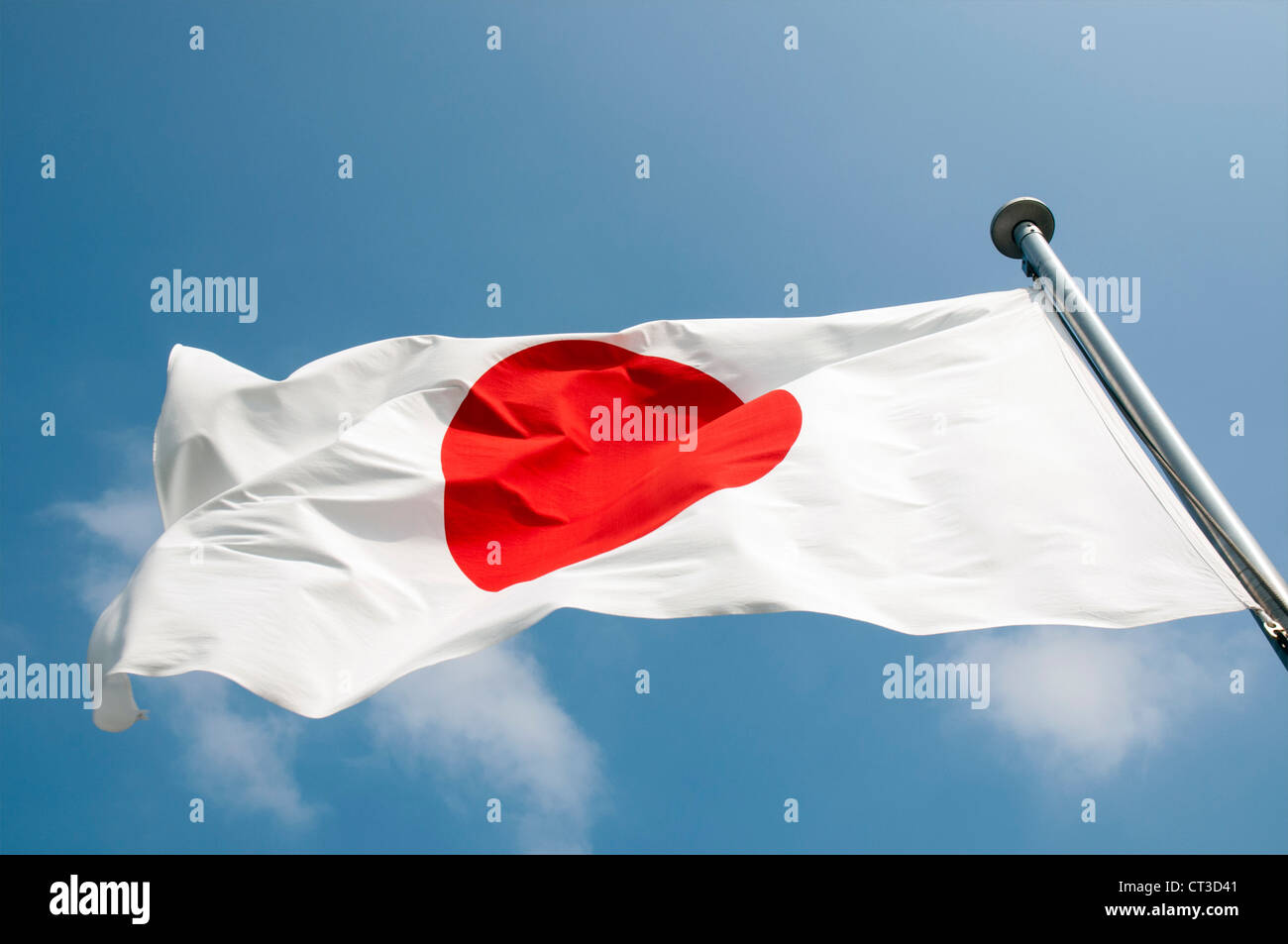 state Japanese flag on the strong wind over blue sky background Stock ...