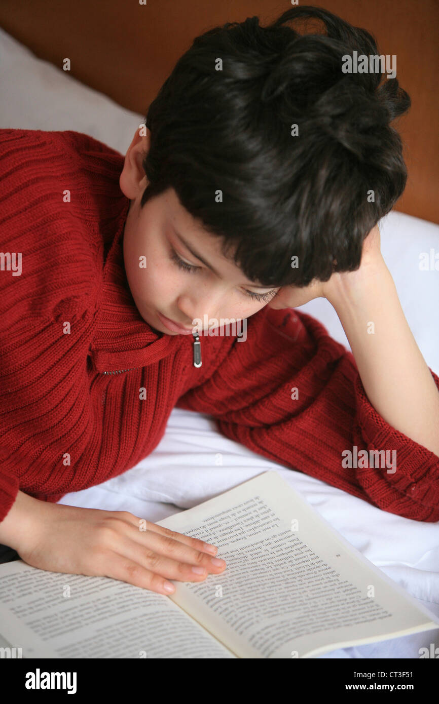 CHILD READING INDOORS Stock Photo - Alamy
