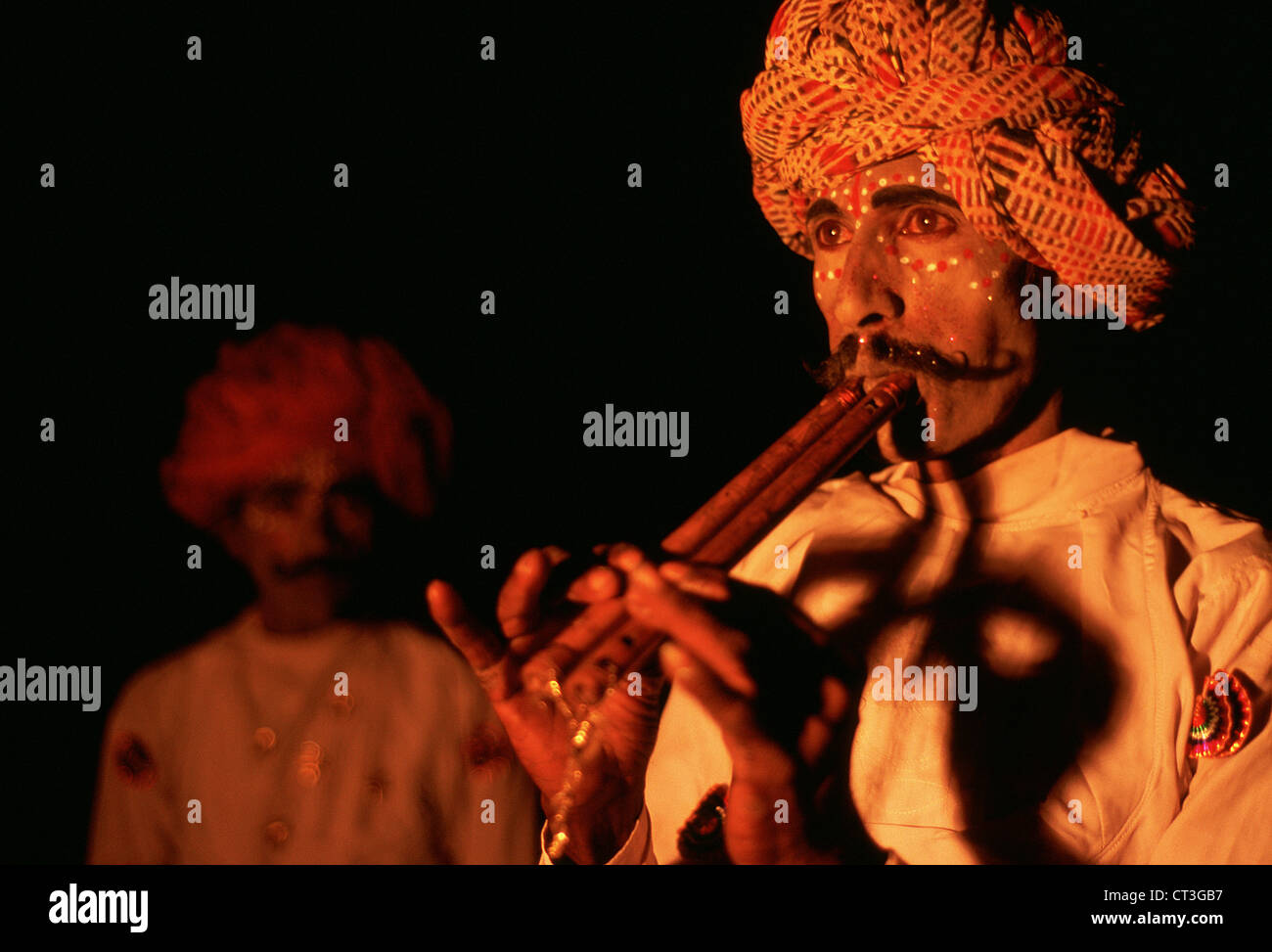 Musician made up and dressed traditionally playing flute ( India Stock ...