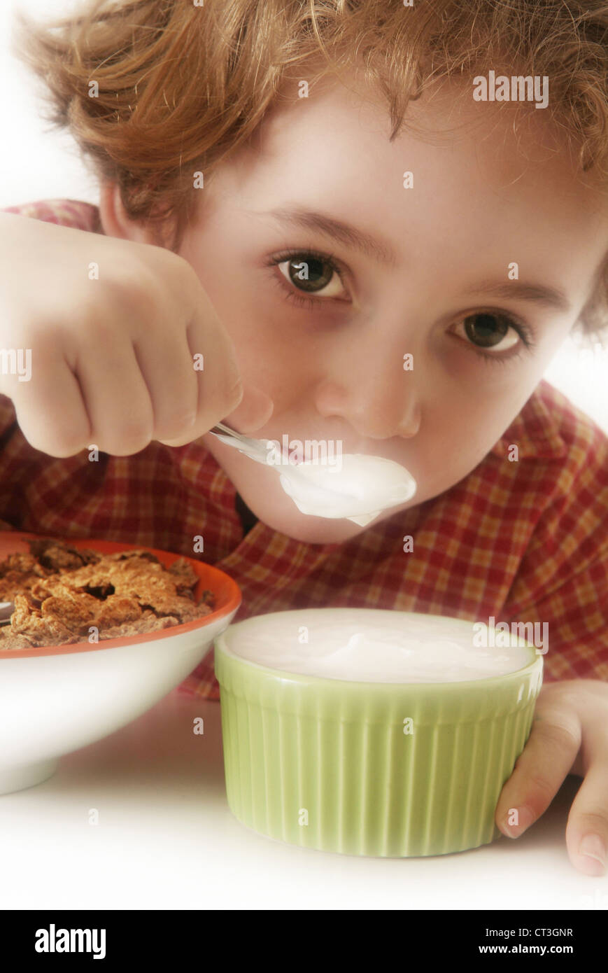 CHILD EATING BREAKFAST Stock Photo - Alamy
