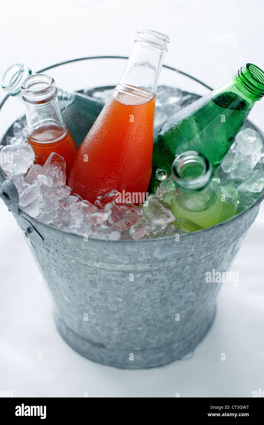 Soda bottles in bucket of ice Stock Photo - Alamy