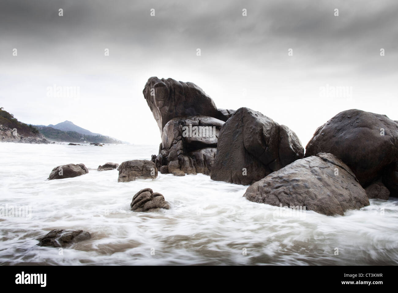 Waves washing over rocks on beach Stock Photo - Alamy