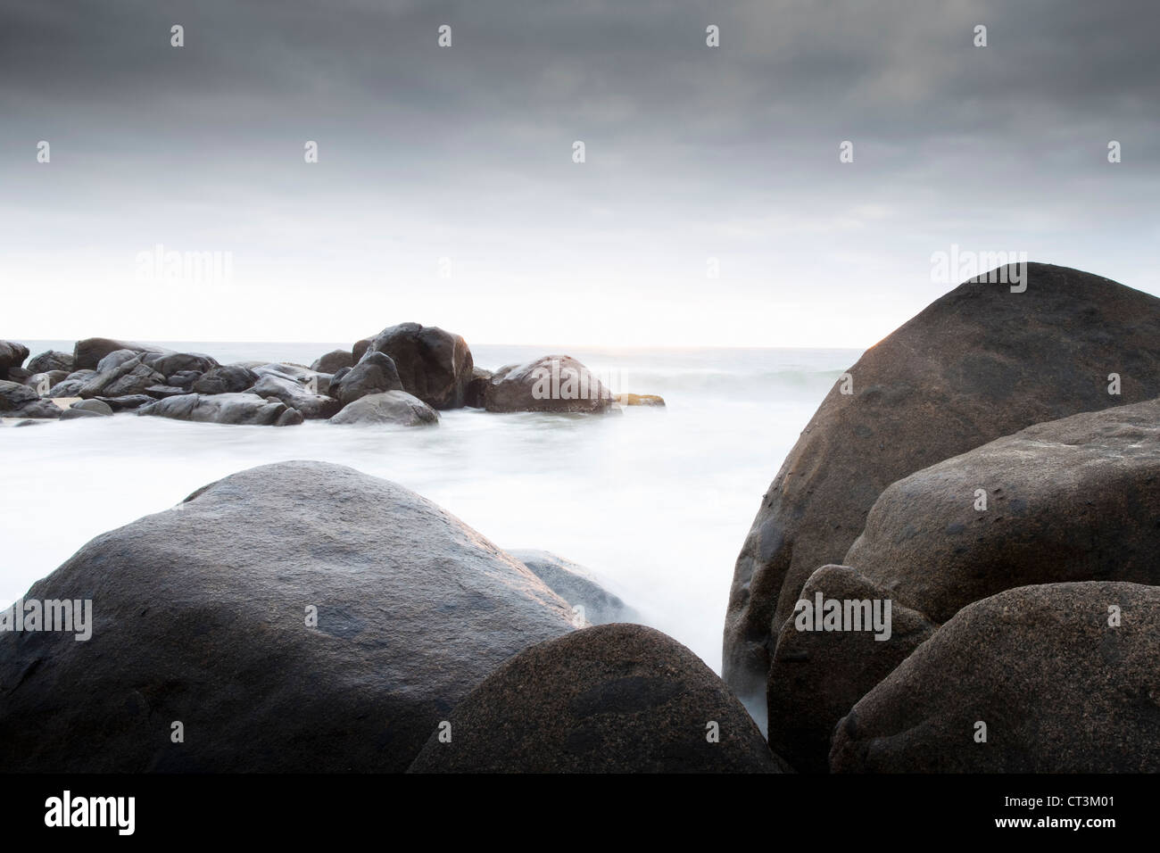 Waves washing over rocks on beach Stock Photo - Alamy