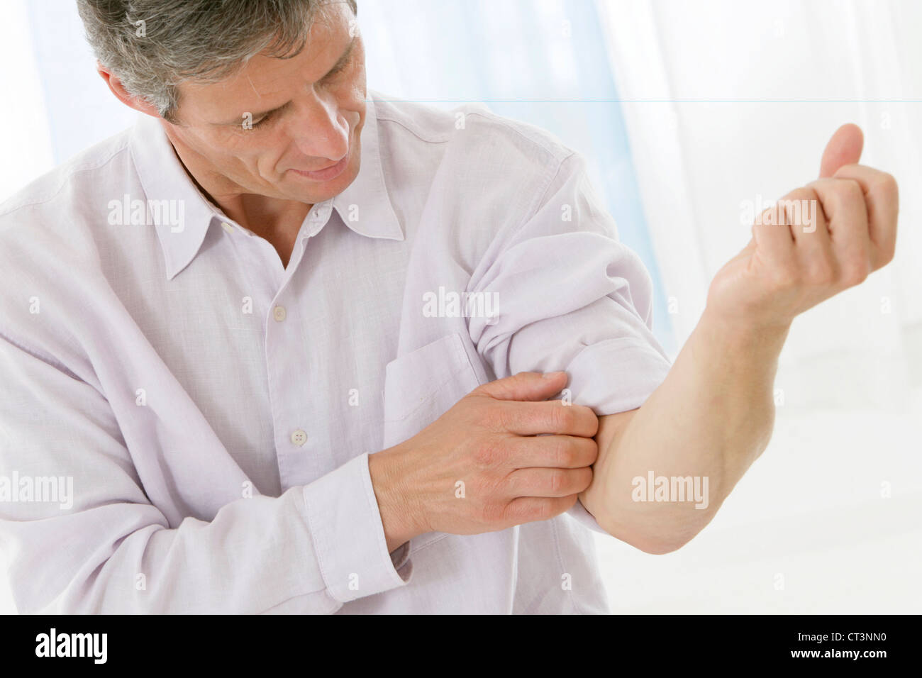 ITCHING IN A MAN Stock Photo - Alamy