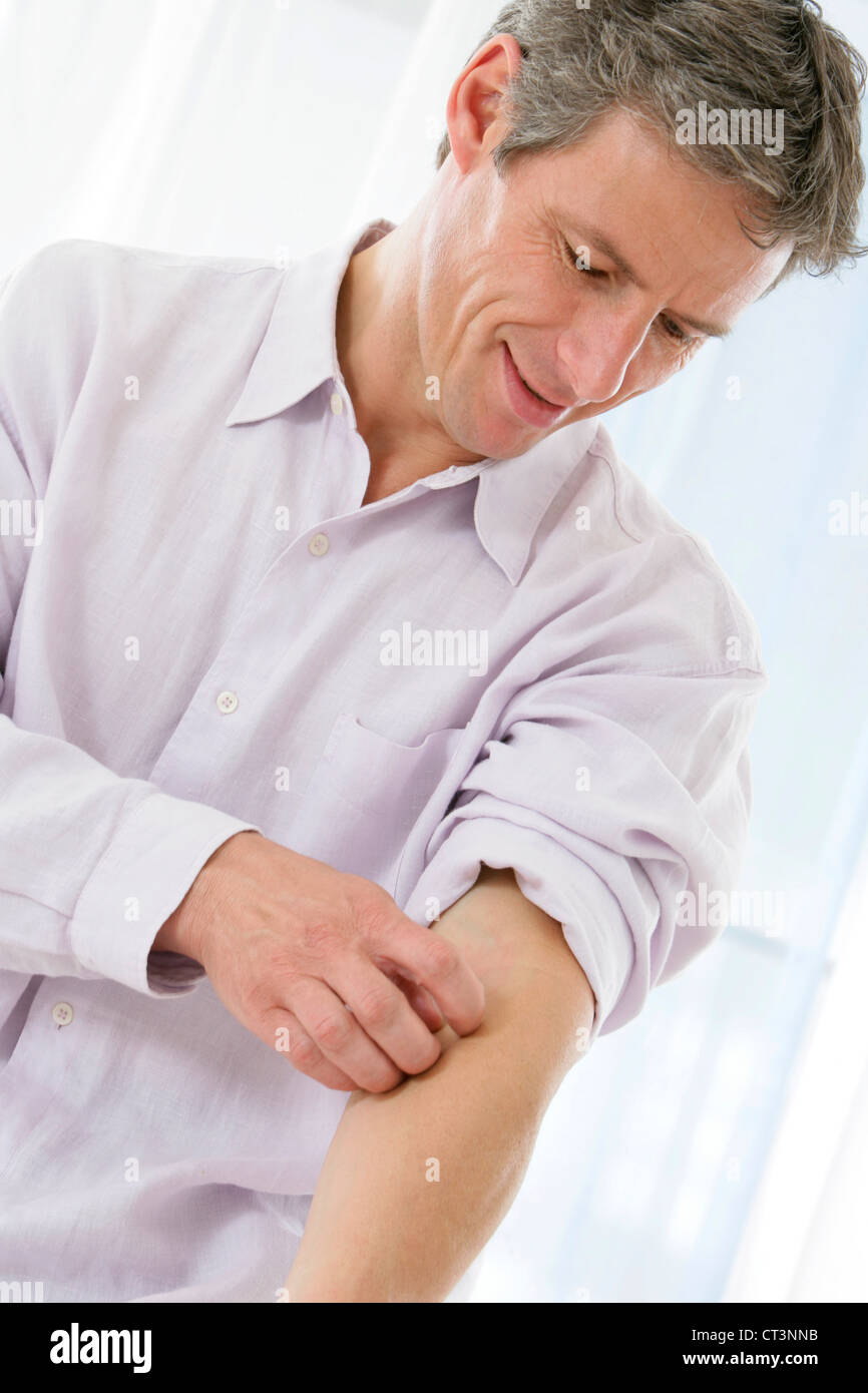 ITCHING IN A MAN Stock Photo - Alamy