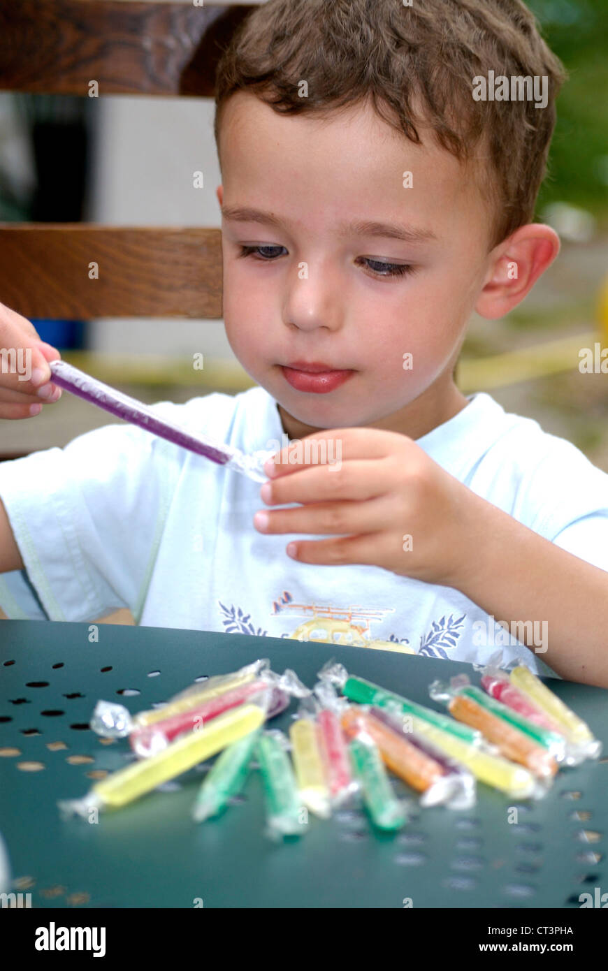 CHILD EATING SWEETS Stock Photo - Alamy