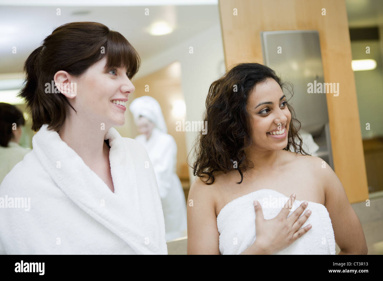 Women wearing towels in locker room Stock Photo - Alamy